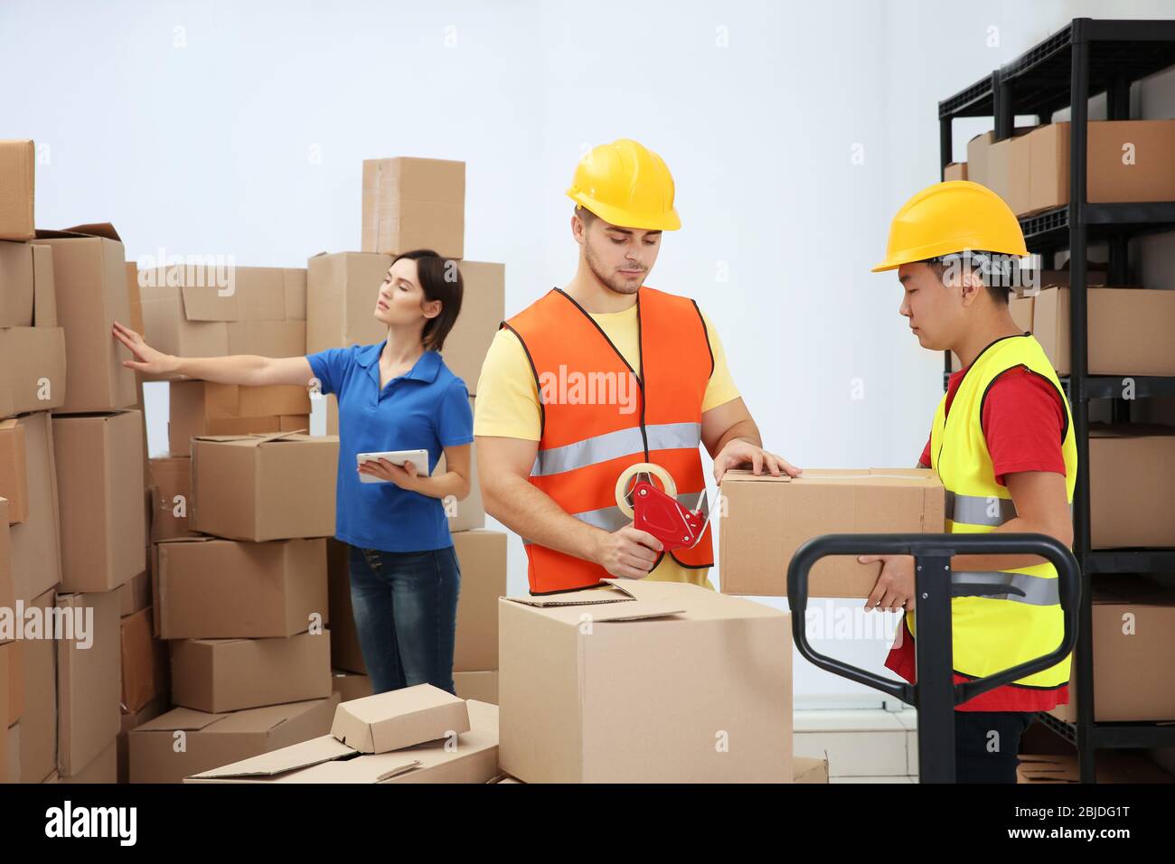 Workers packing parcels at warehouse Stock Photo - Alamy