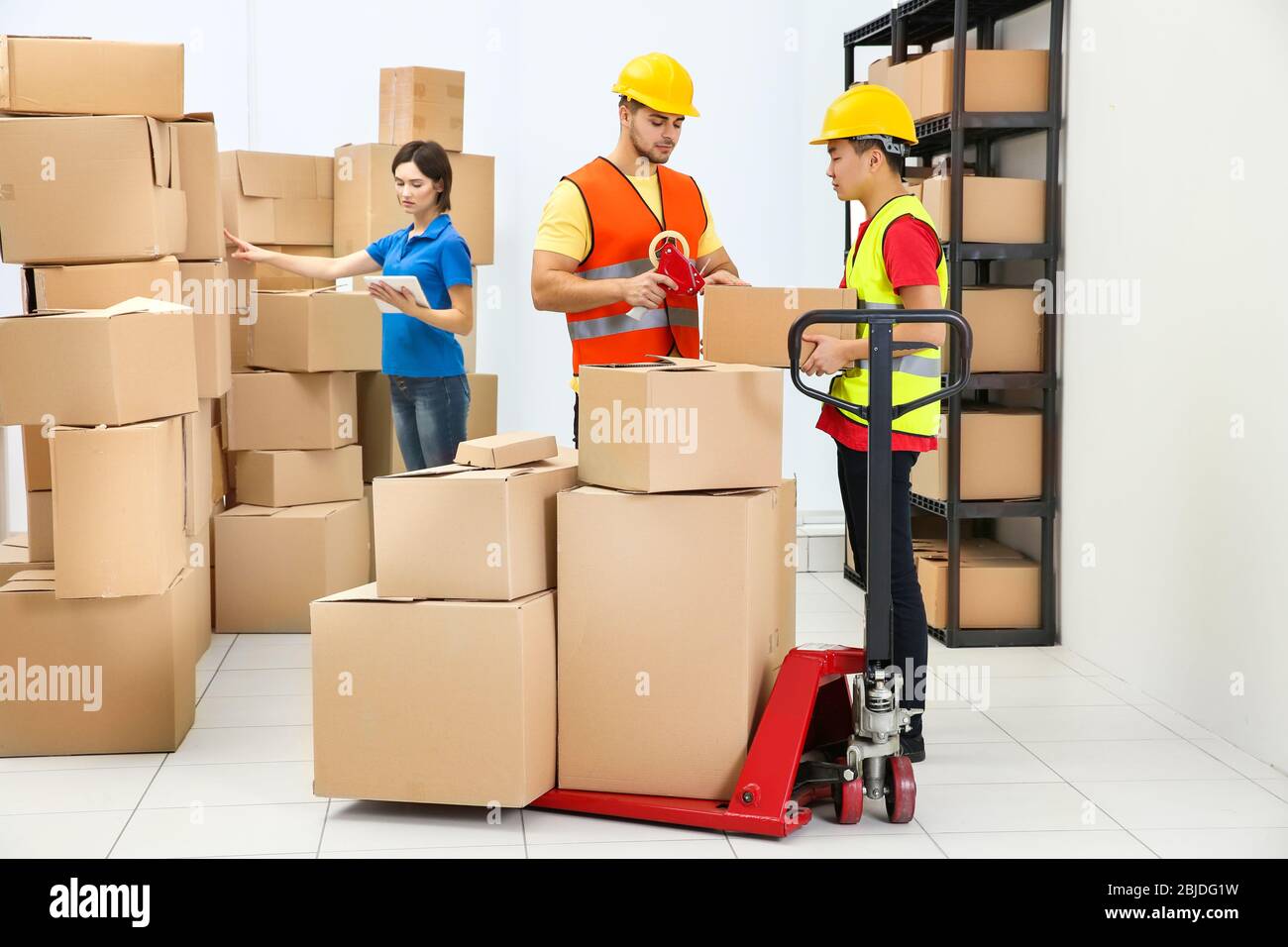 Workers packing parcels at warehouse Stock Photo - Alamy