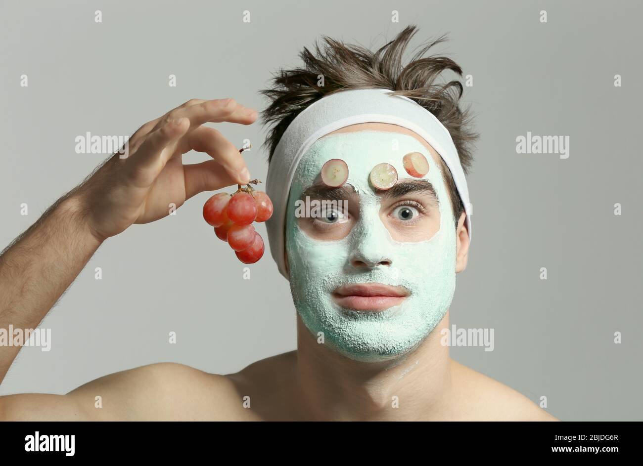 Man with cosmetic mask on face, gray background Stock Photo - Alamy