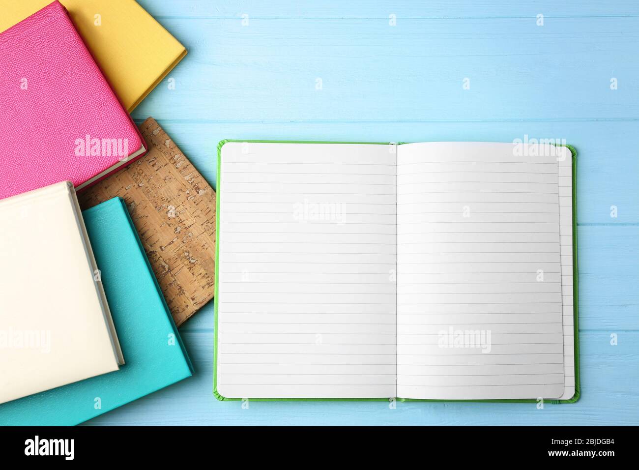 Colorful notebooks on wooden background Stock Photo - Alamy