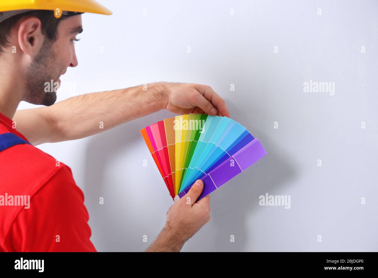 Worker holding samples for choosing color of wall, closeup Stock Photo ...