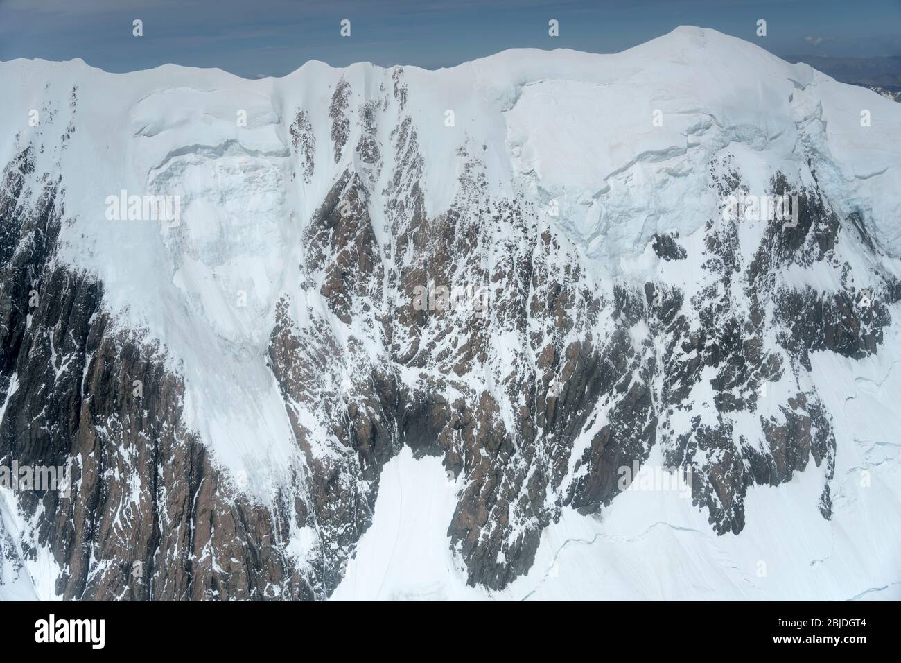aerial, from a glider, with snow heaps and landslides at Mt. Cook range ...