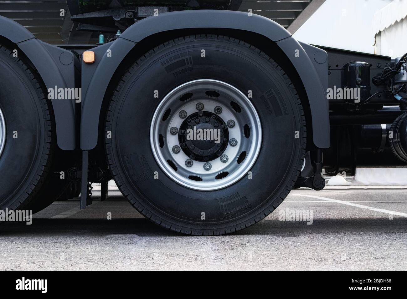 Truck tire, wheel of heavy duty semi truck, close up. Freight industry ...