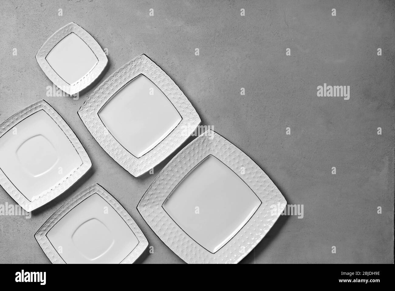 Empty dishes on grey background Stock Photo - Alamy
