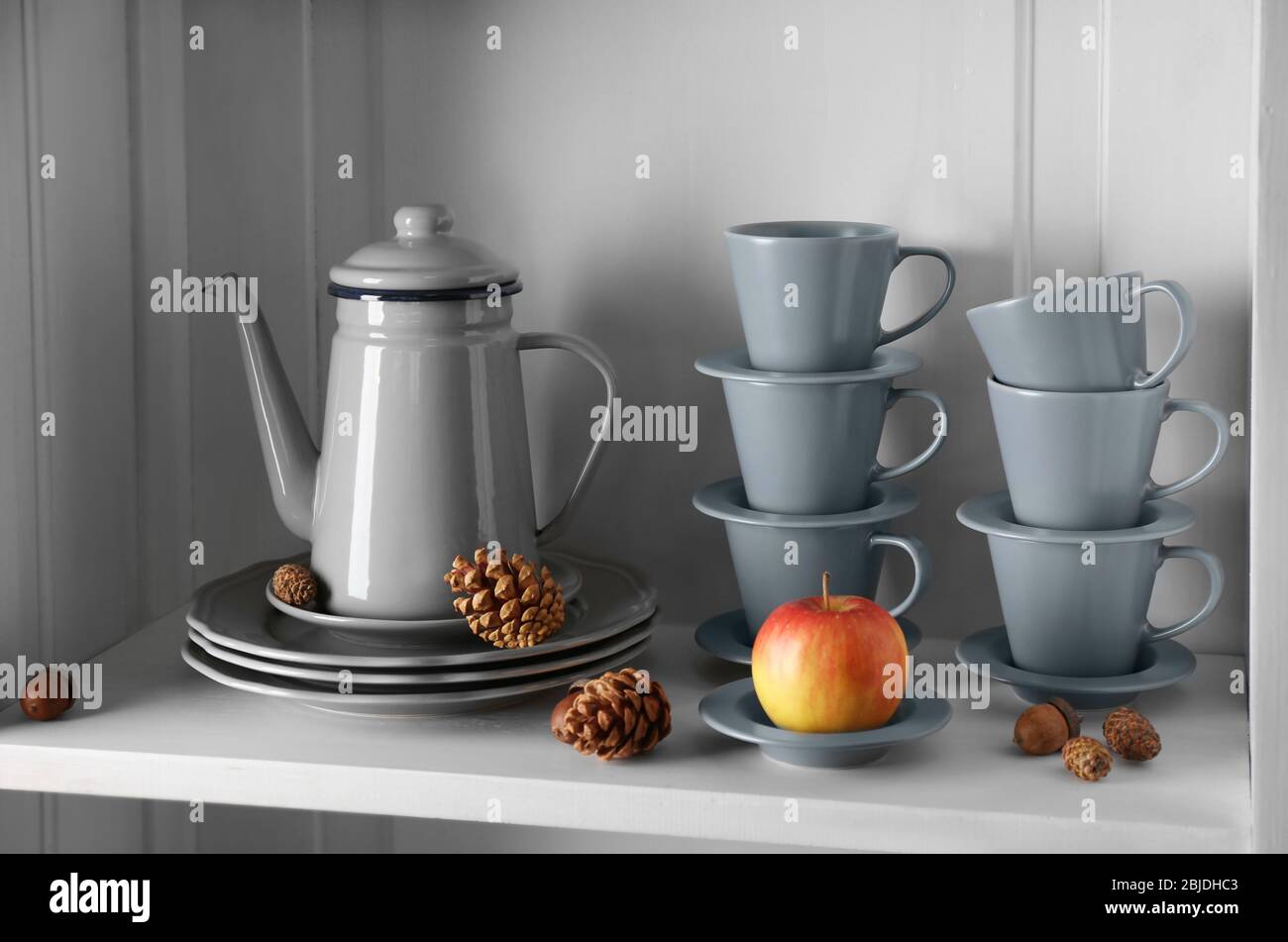Tea set in wooden cupboard Stock Photo - Alamy