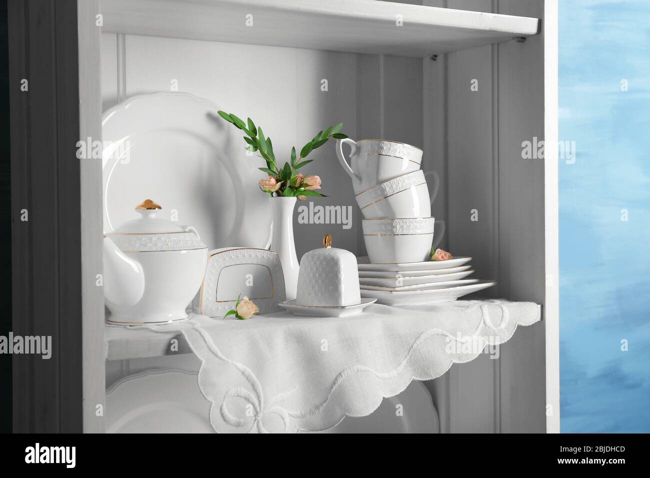 Tea set in wooden cupboard Stock Photo - Alamy