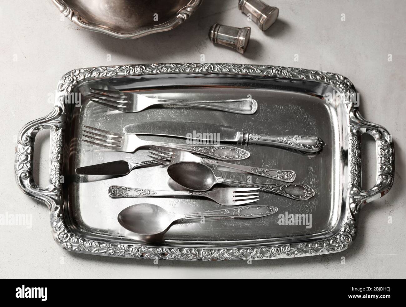 Set of silverware on grey background Stock Photo - Alamy