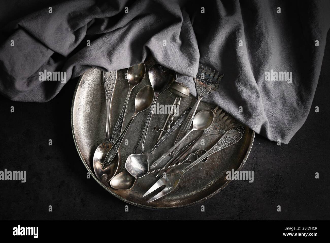 Set of silverware on grey background Stock Photo - Alamy