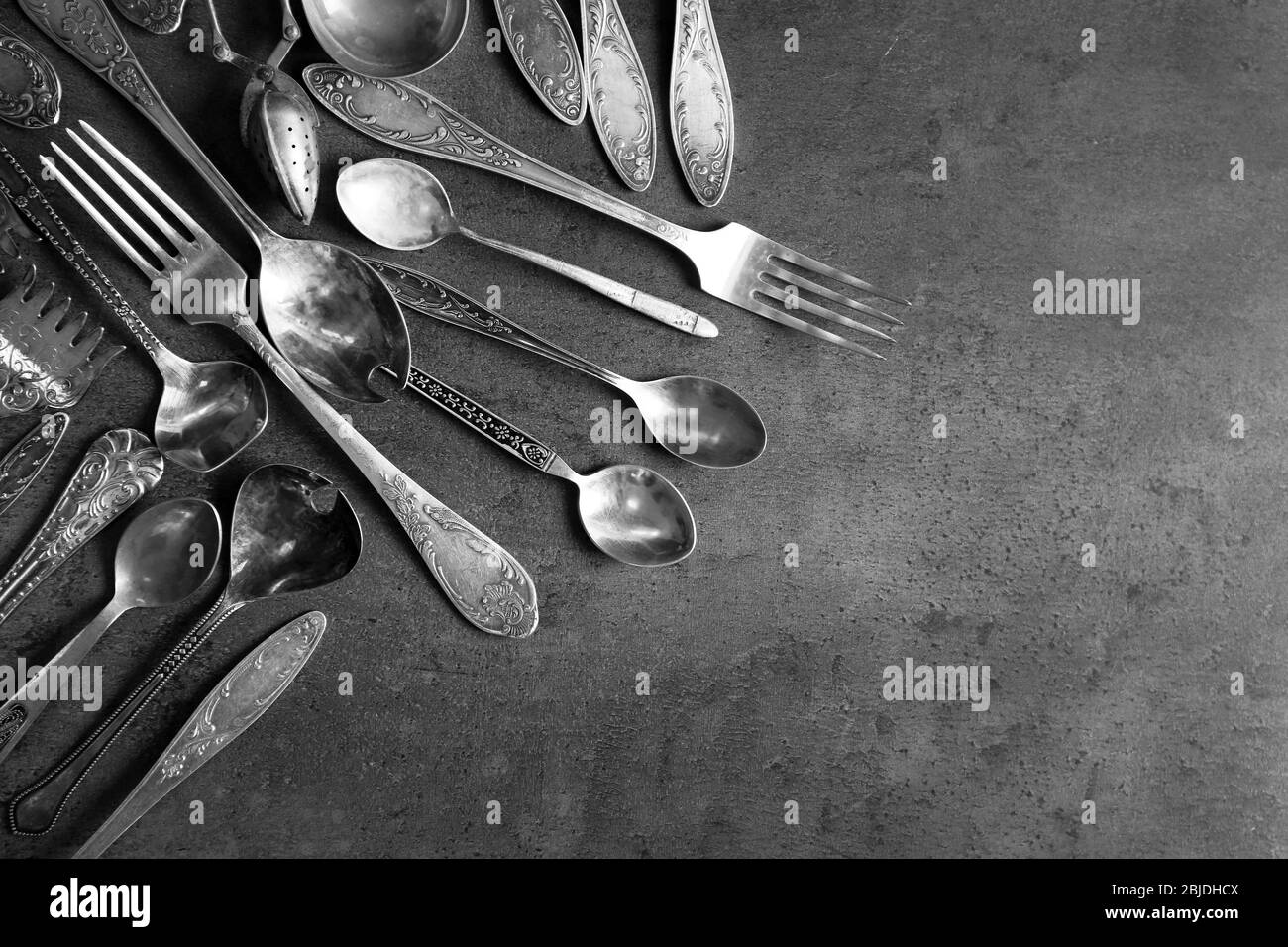 Set of silverware on grey background Stock Photo - Alamy