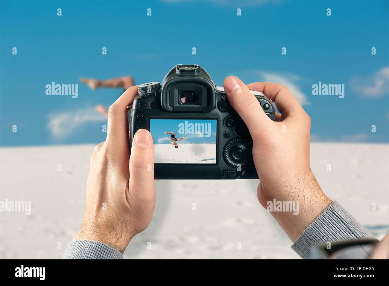 Digital single-lens reflex camera in hands. Photographer shooting hands ...