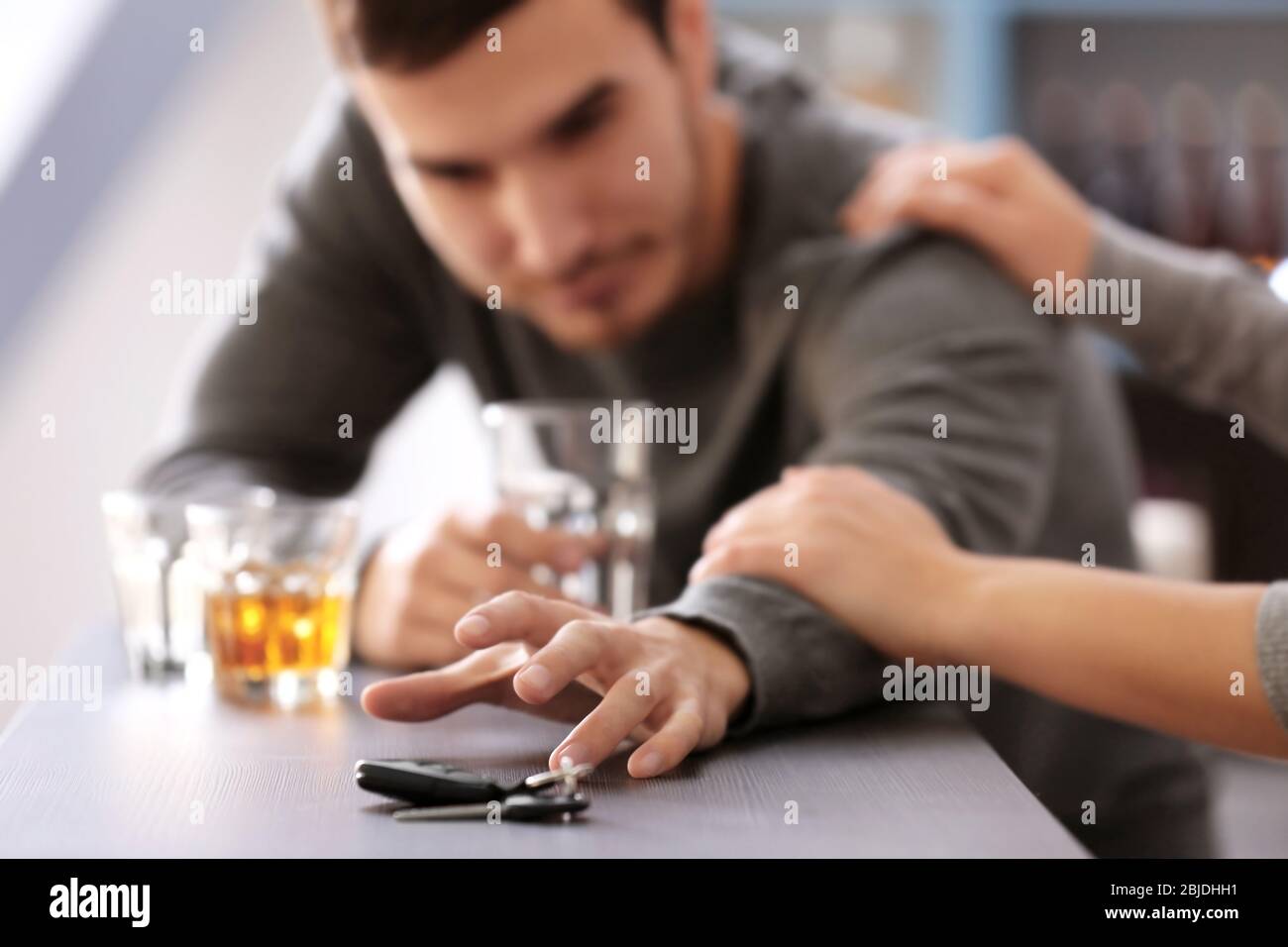 Woman preventing drunk man from taking car keys, closeup. Don't drink ...