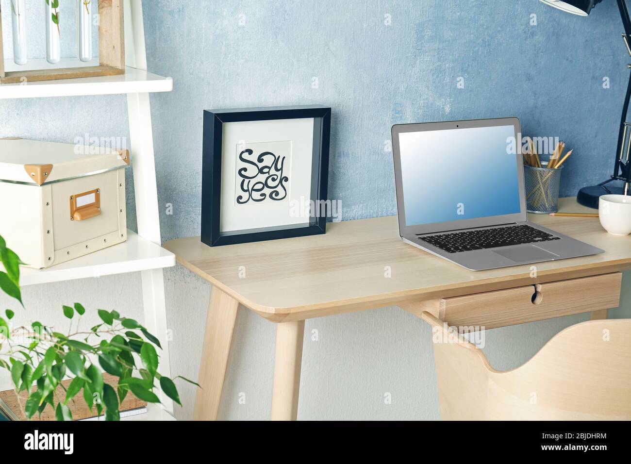Workplace with laptop on table in modern room Stock Photo - Alamy
