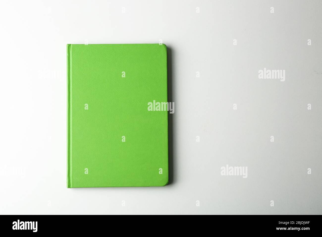 Blank green notebook on white background Stock Photo - Alamy