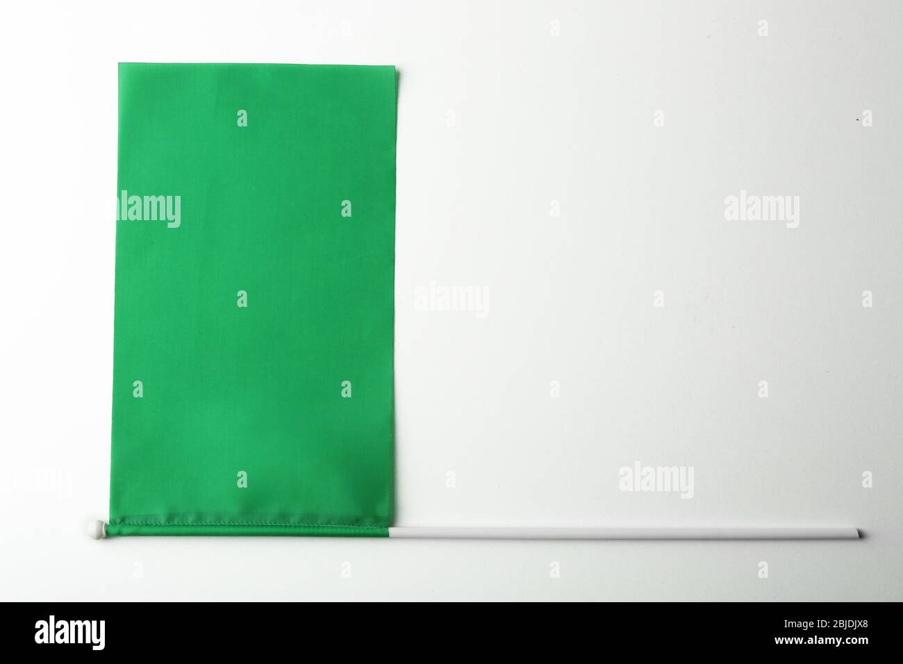 Blank green flag on white background Stock Photo - Alamy