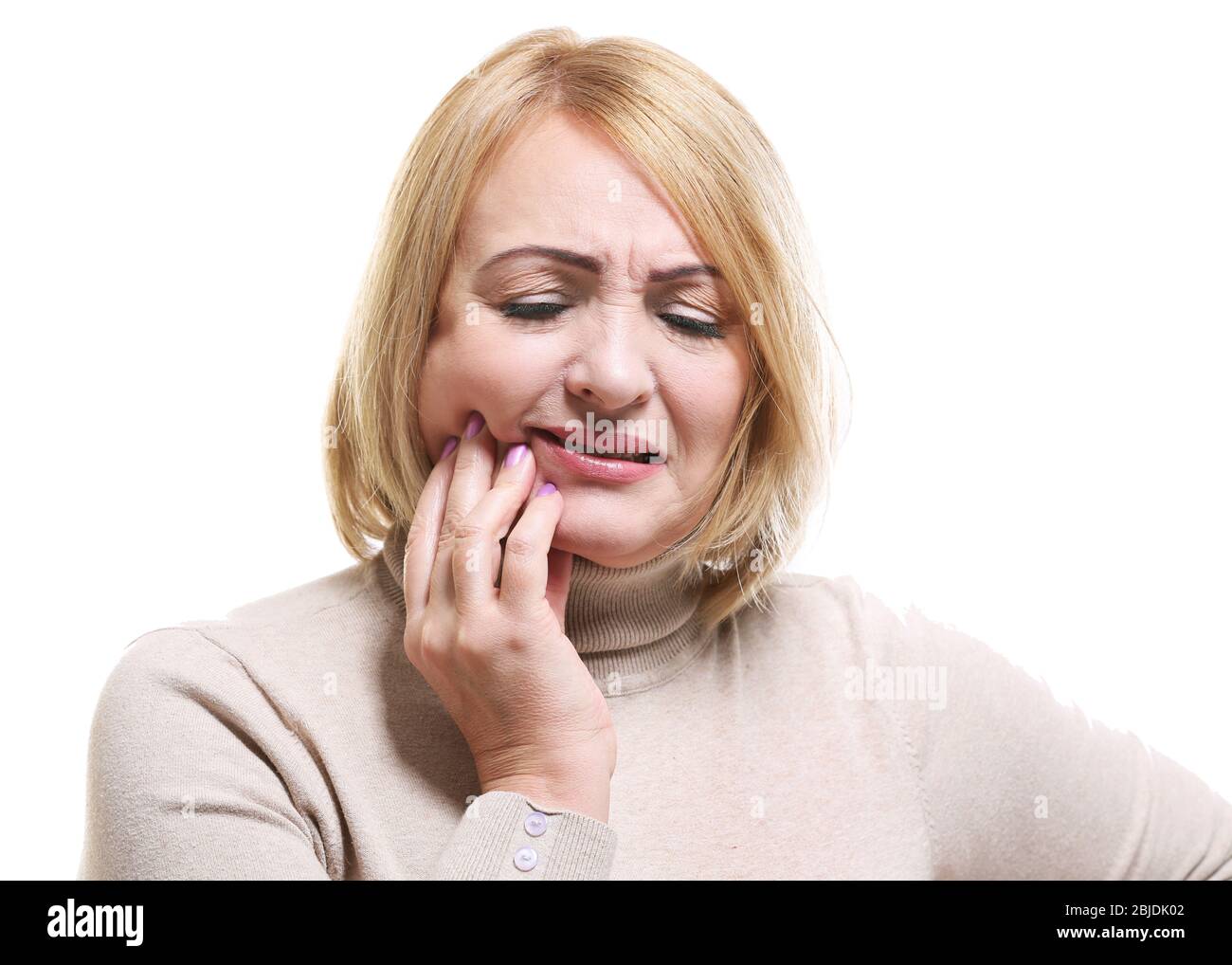 Senior woman suffering from toothache on white background Stock Photo ...