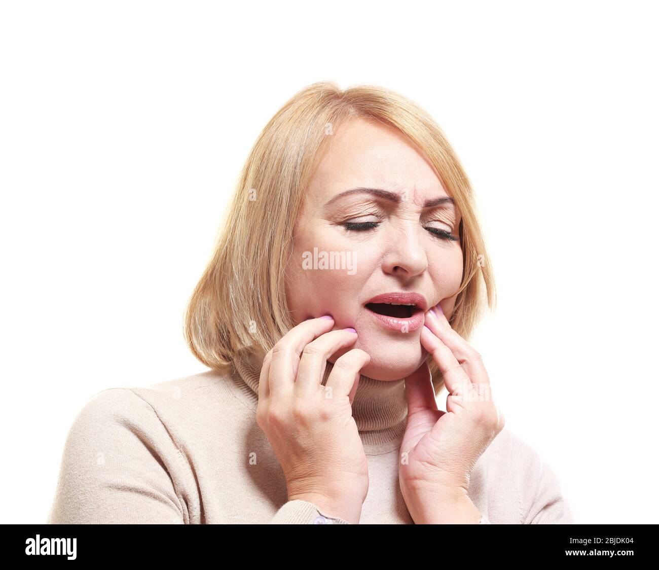 Senior woman suffering from toothache on white background Stock Photo ...