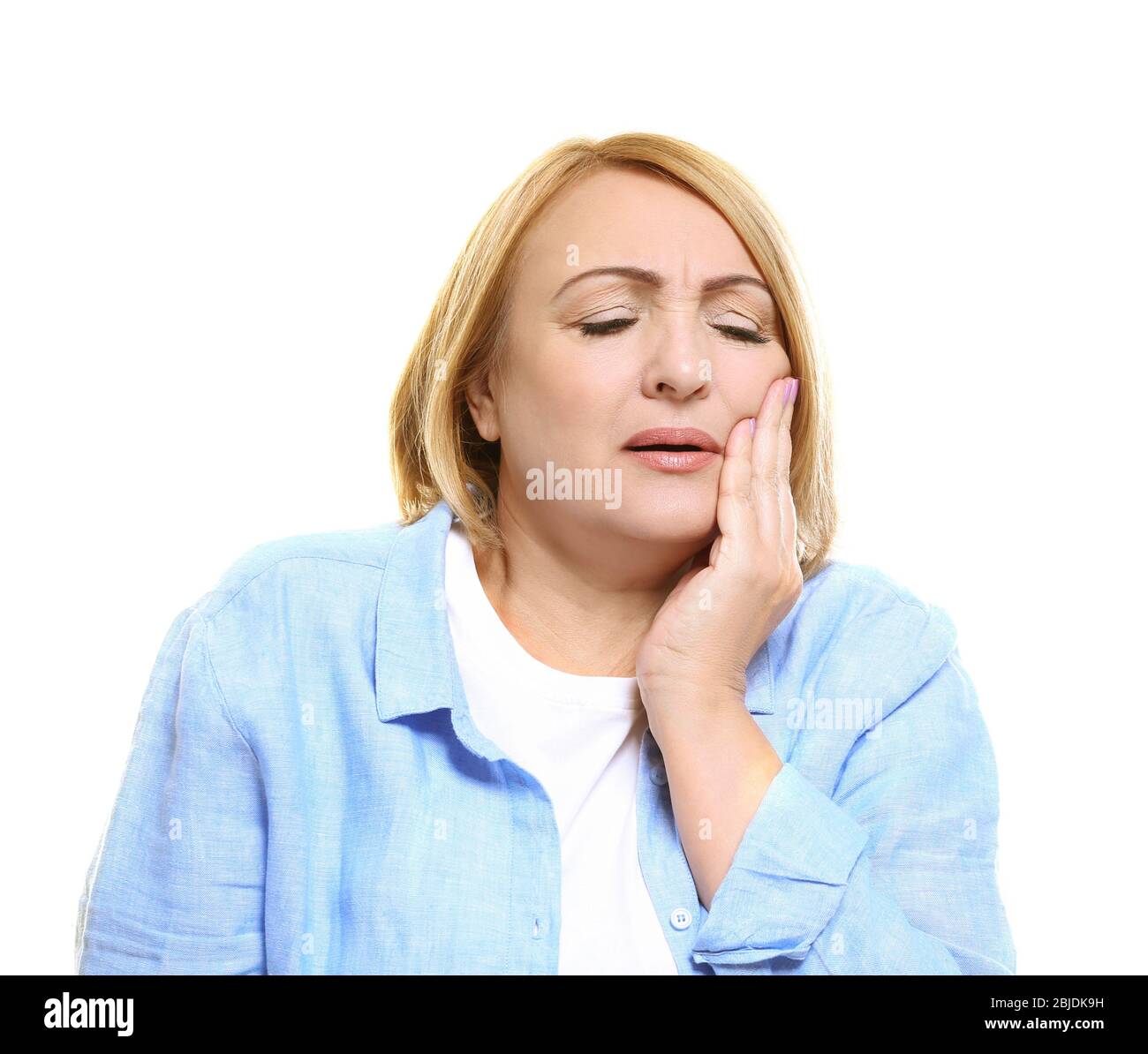 Senior woman suffering from toothache on white background Stock Photo ...