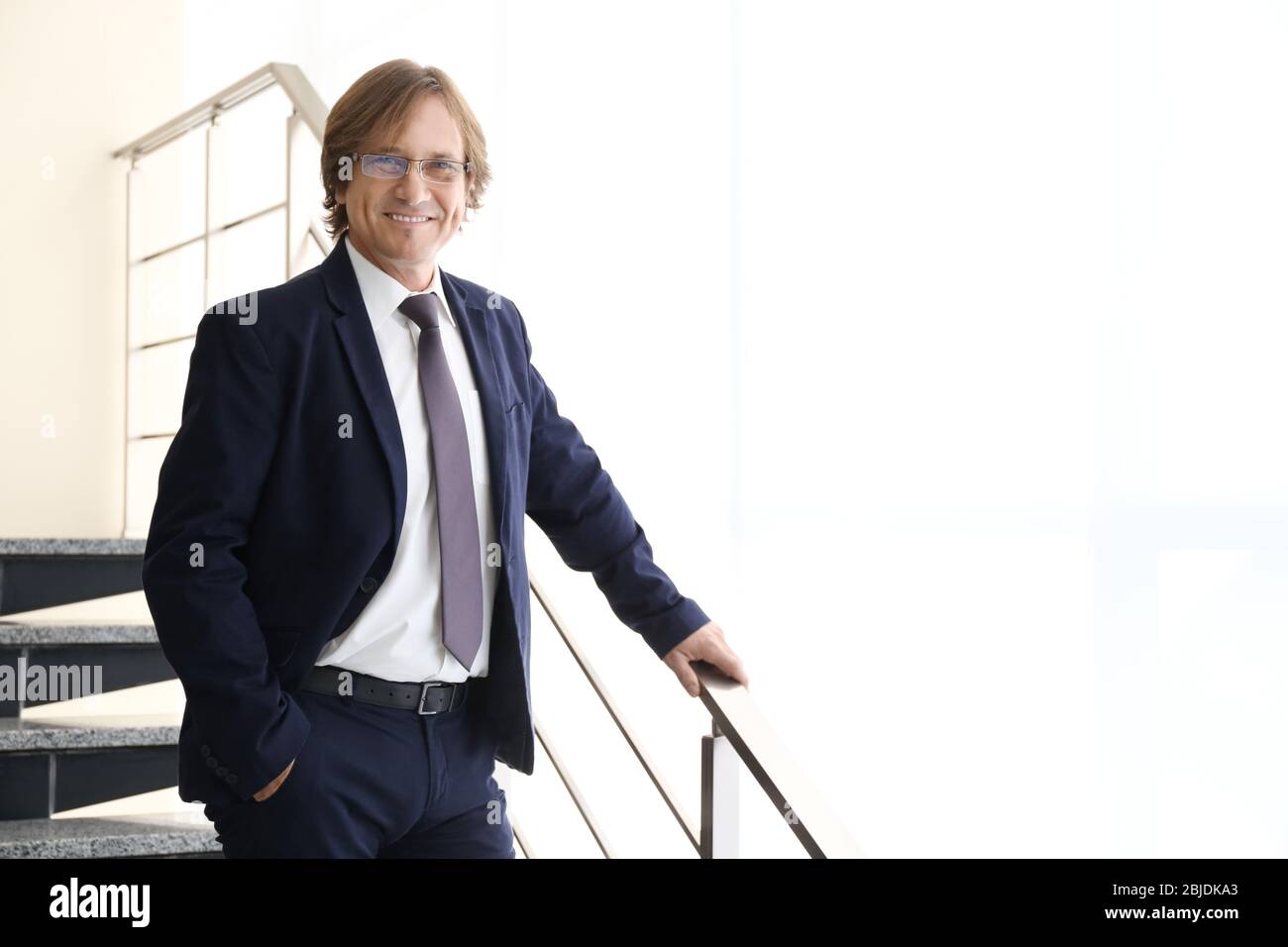 Man standing on stairs hi-res stock photography and images - Alamy