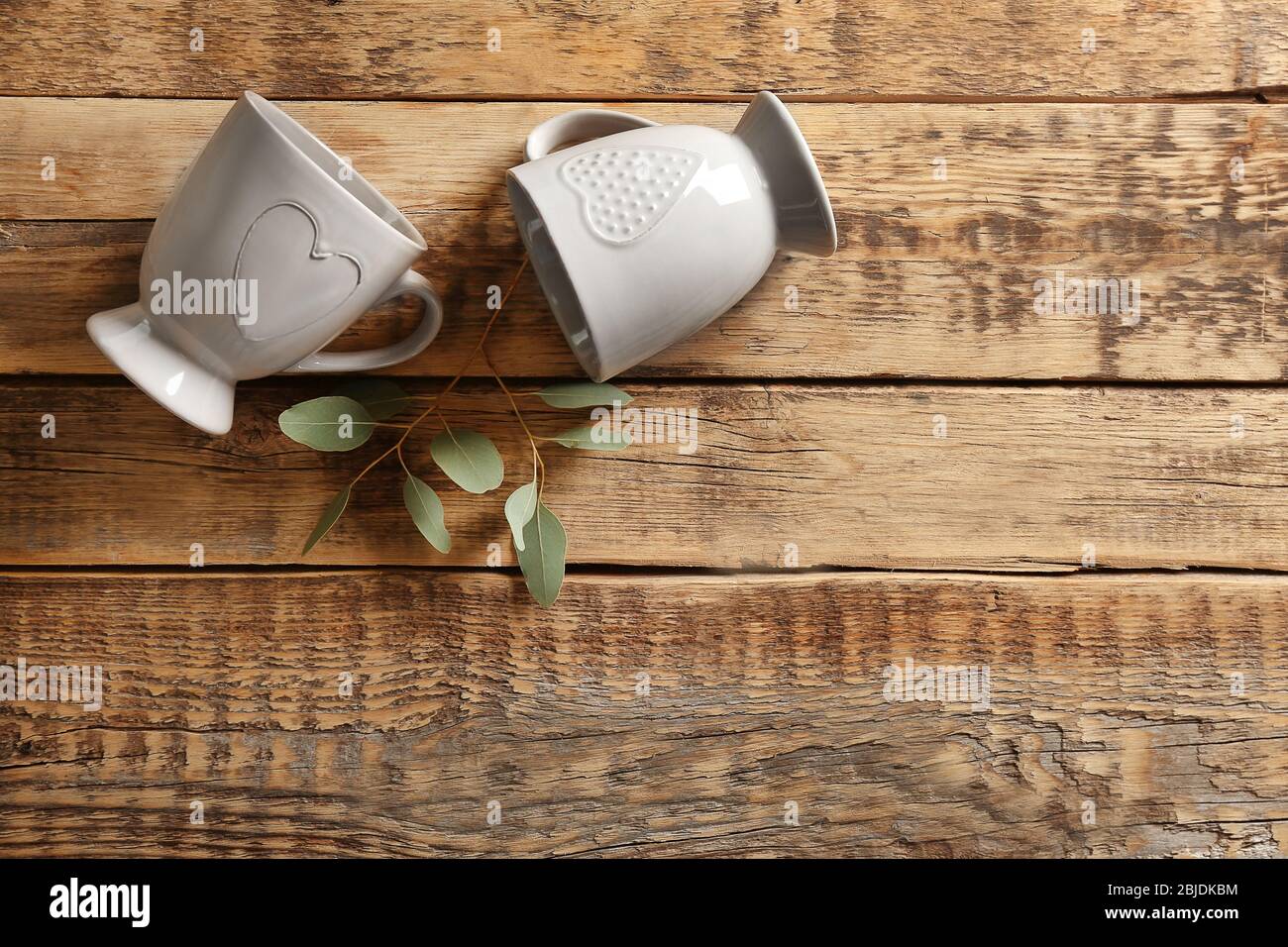 Two cups on wooden table, top view Stock Photo - Alamy