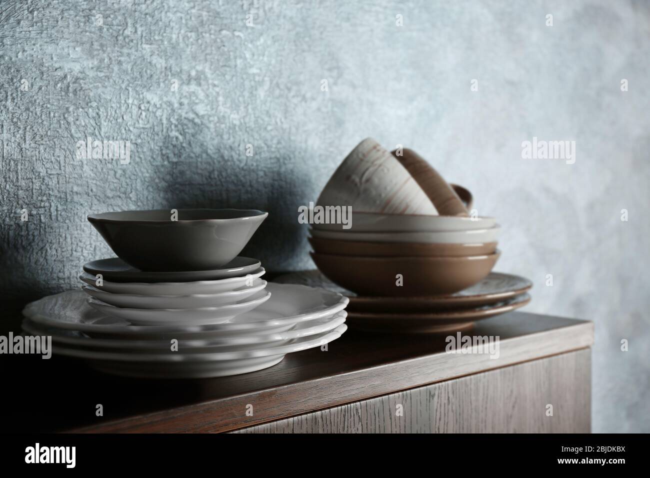Set of dinnerware on gray background Stock Photo - Alamy