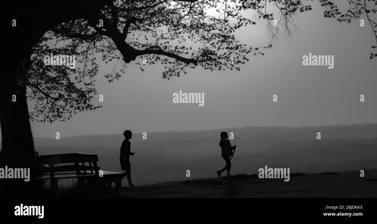 Kids playing grass clouds hi-res stock photography and images - Alamy