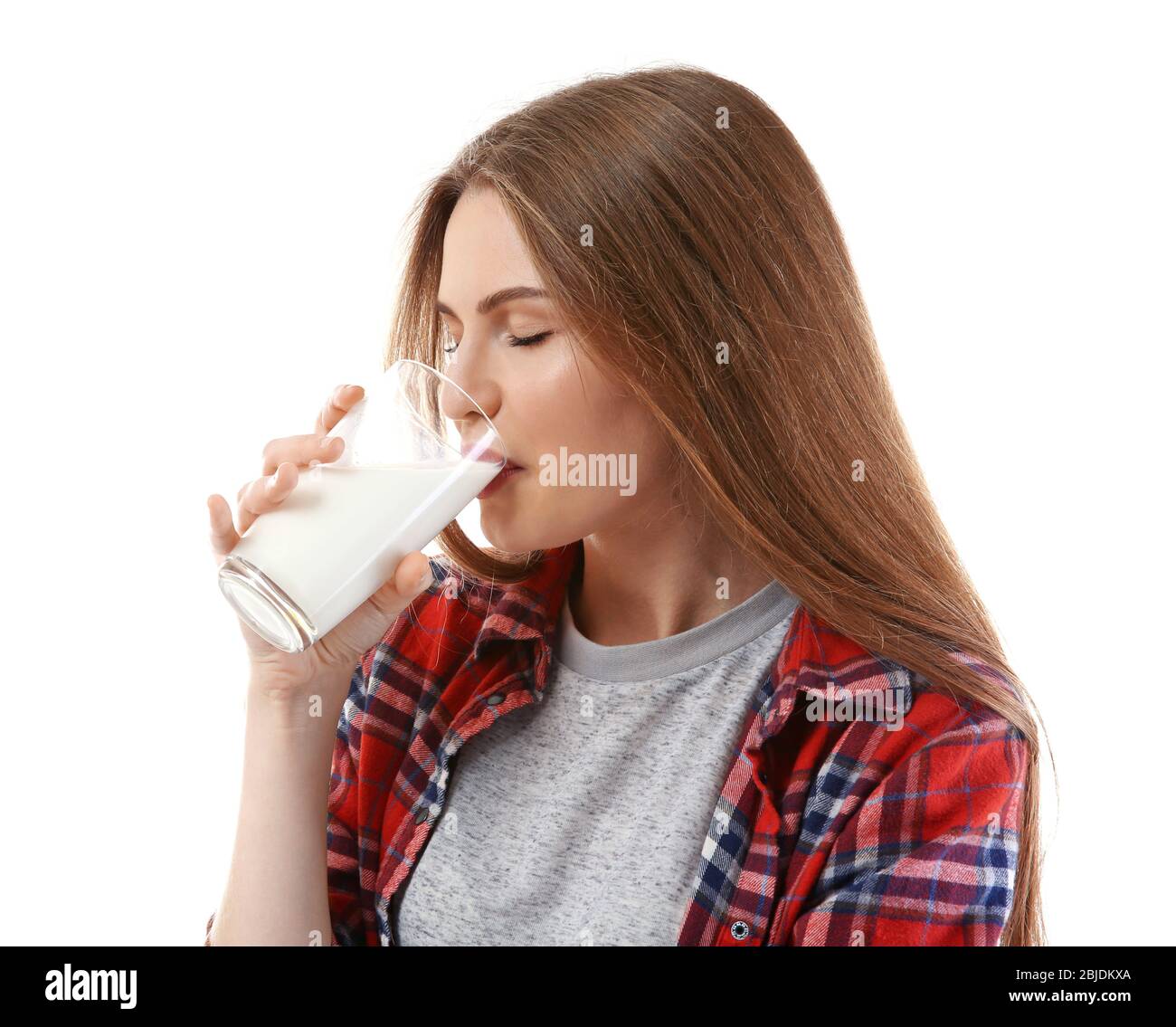 Beautiful young woman drinking milk on white background Stock Photo - Alamy