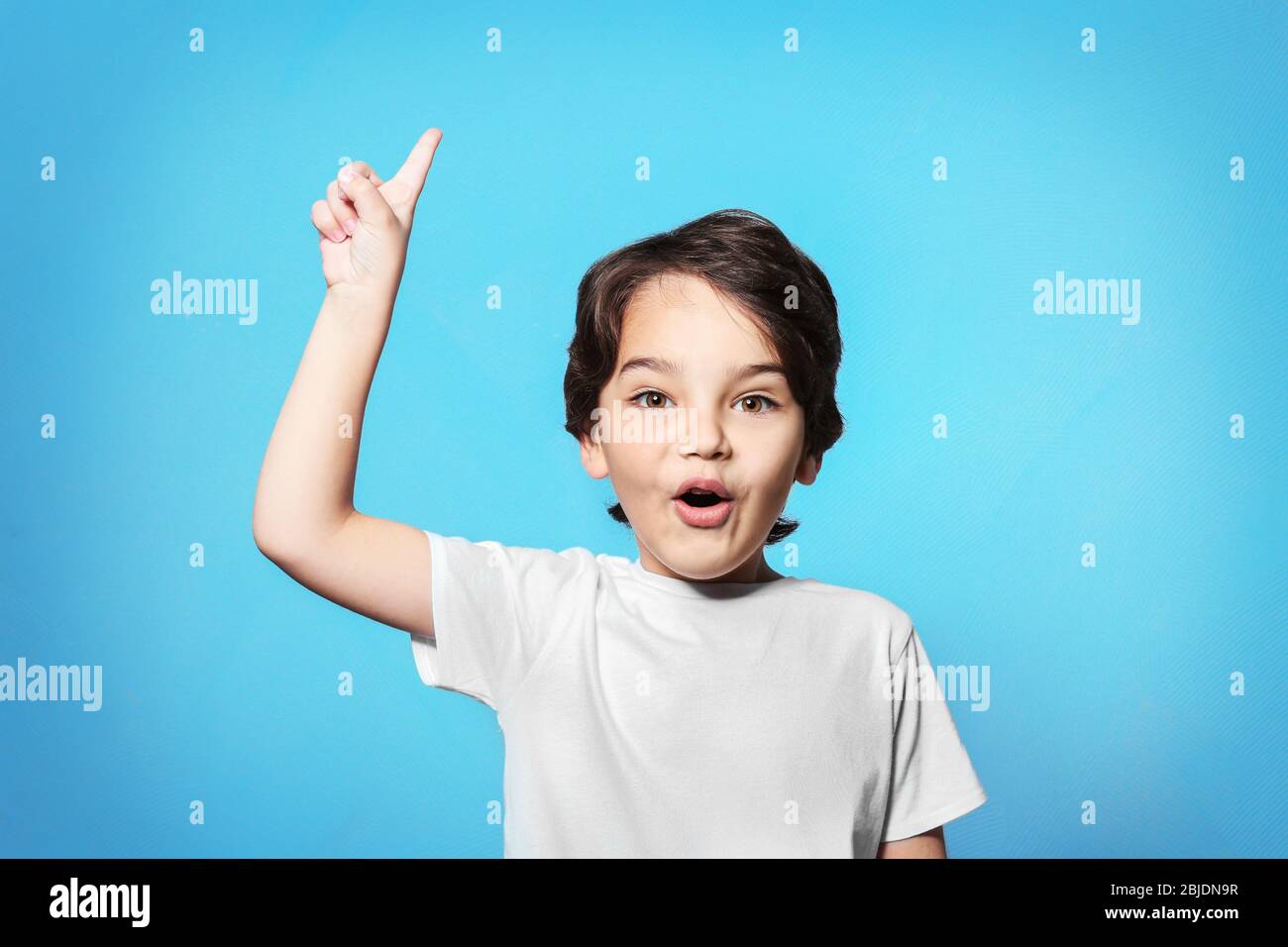 Cute emotional little boy on blue background Stock Photo - Alamy