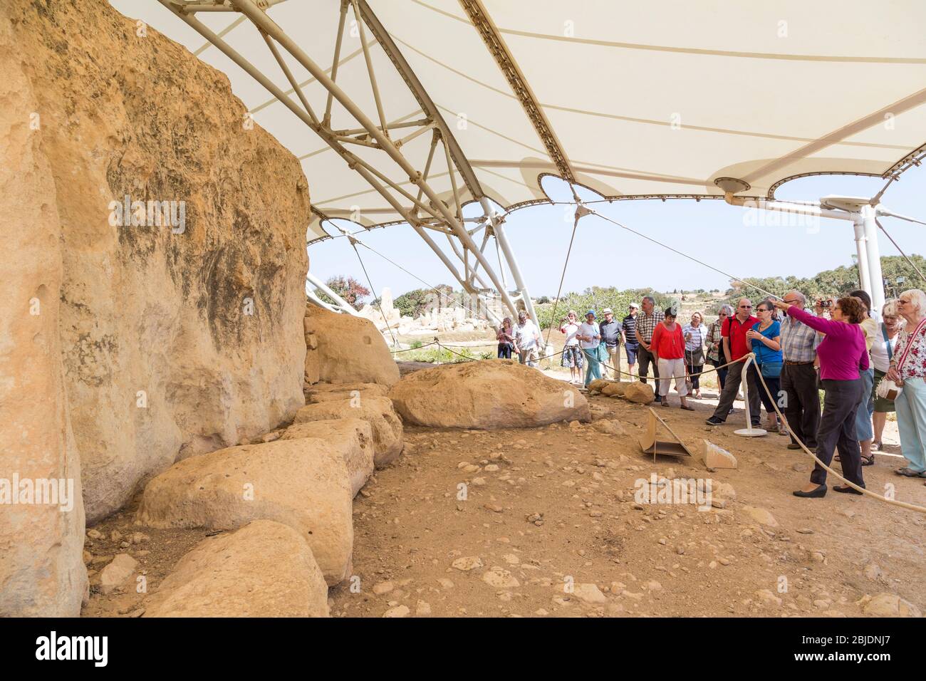 Tour group with guide at Hagar Qim prehistoric temple, Qrendi, Malta ...