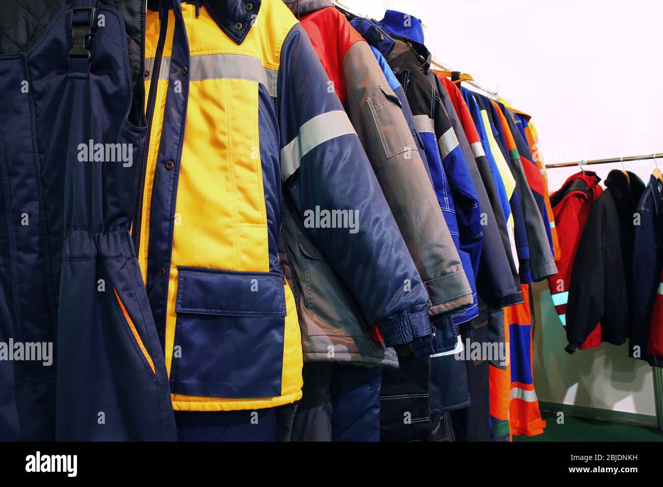 Work clothes on hangers, closeup Stock Photo - Alamy