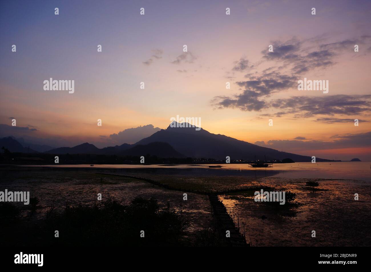 sunset or sunrise behind the mountain, north coast of the island of ...