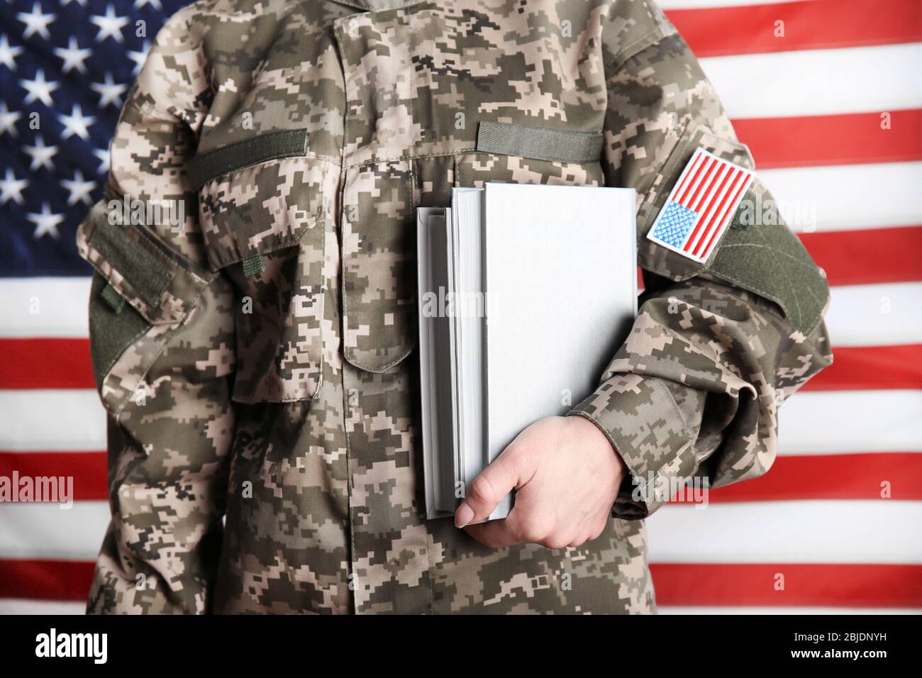 Close up view of female soldier with books on USA flag background Stock ...