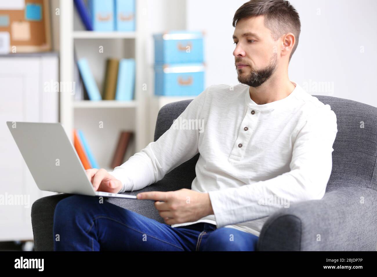 Handsome young programmer working with laptop at home Stock Photo - Alamy