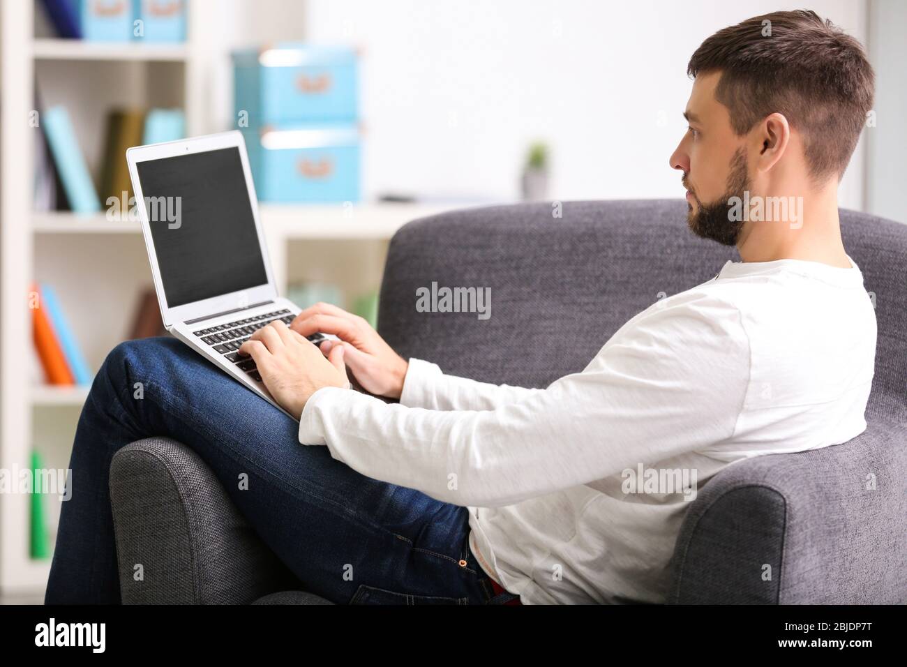 Handsome young programmer working with laptop at home Stock Photo - Alamy