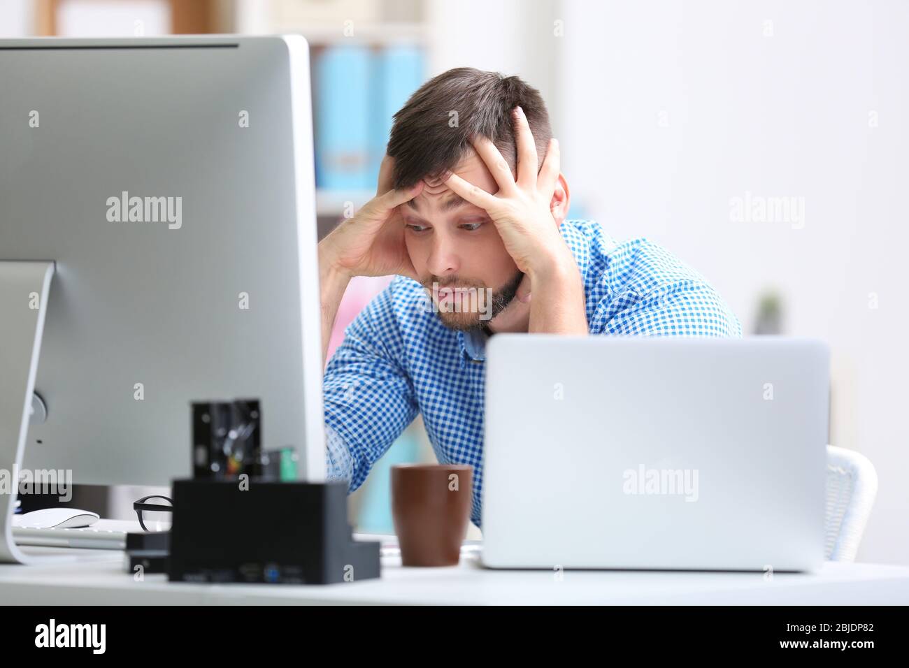 Handsome young programmer working in office Stock Photo - Alamy