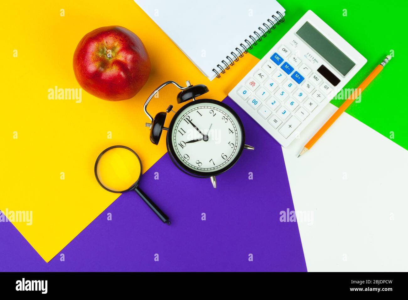Black alarm clock on color block background, office interior Stock ...