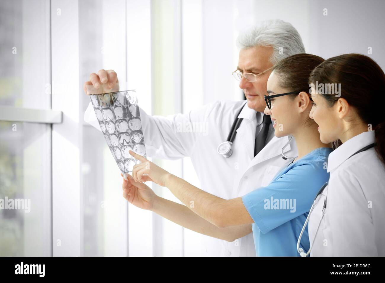 Group of doctors looking at roentgenogram in clinic Stock Photo - Alamy