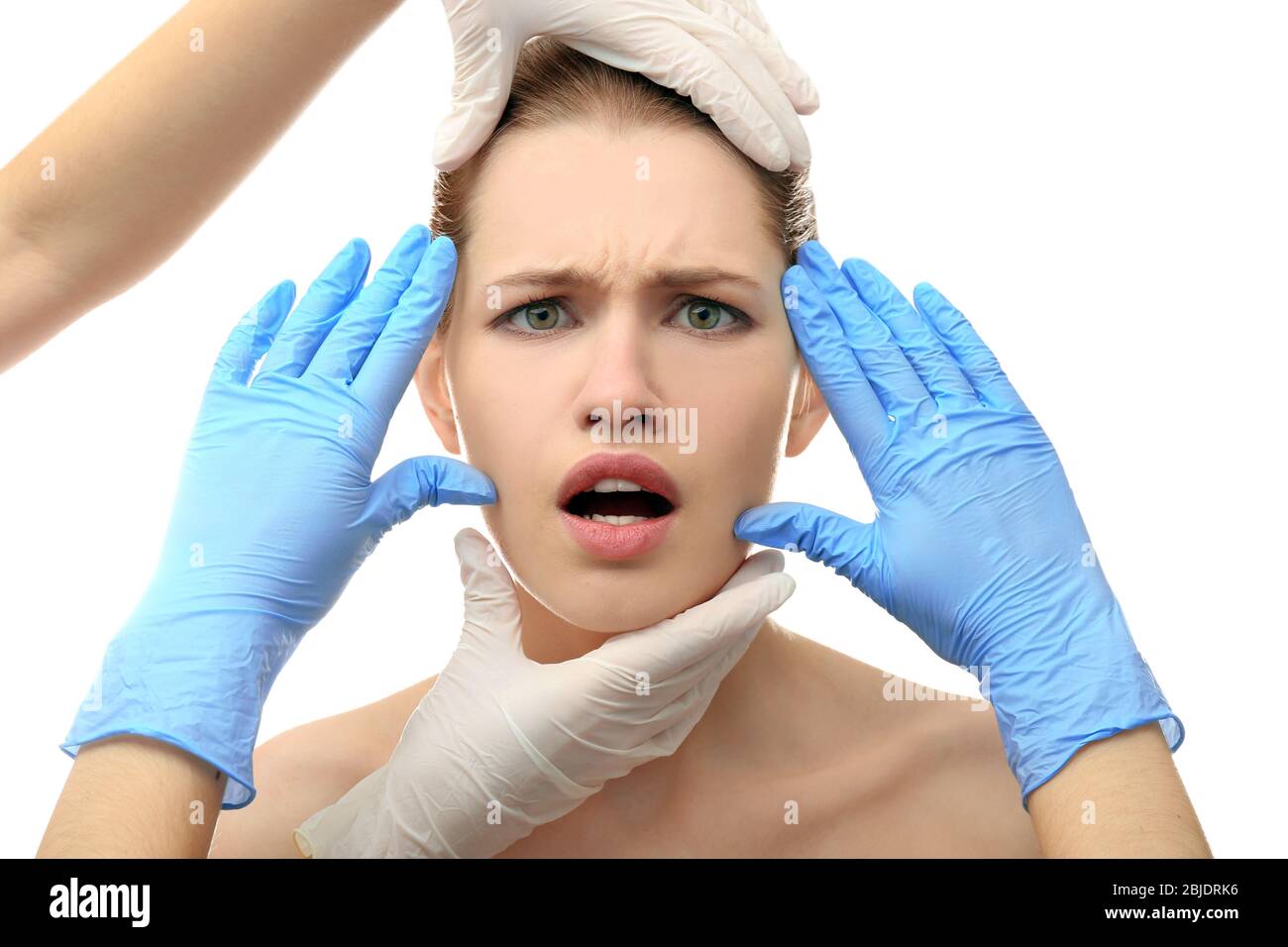 Hands touching female face on white background. Plastic surgery concept ...