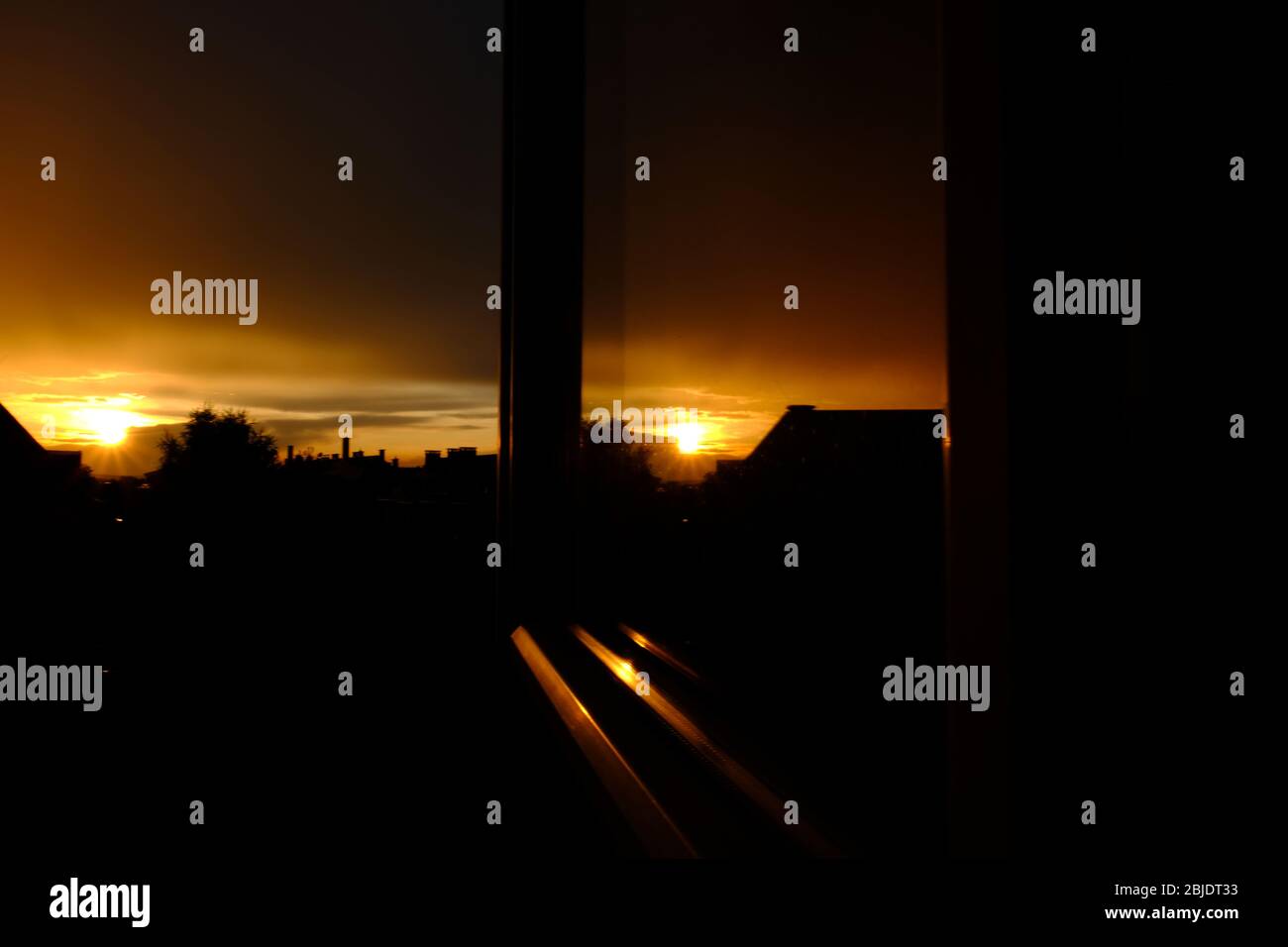 Twin sunset in my window Stock Photo - Alamy