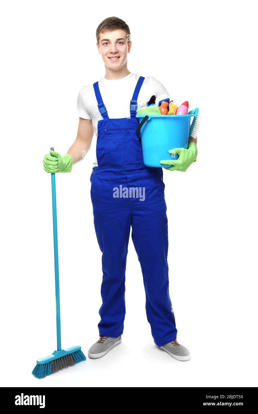 Young man holding cleaning equipment and supplies on white background ...