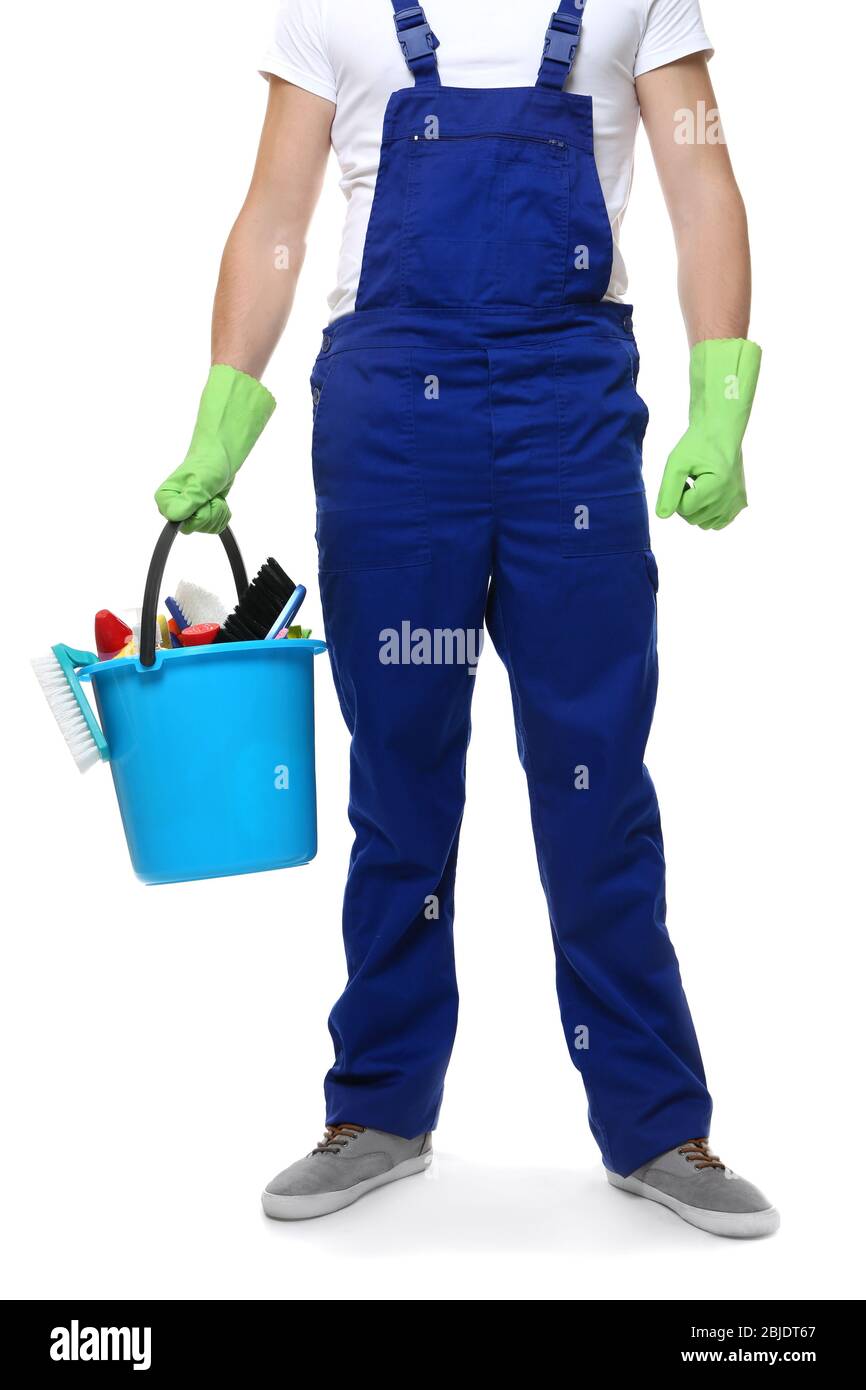 Young man holding bucket with cleaning equipment and supplies on white ...