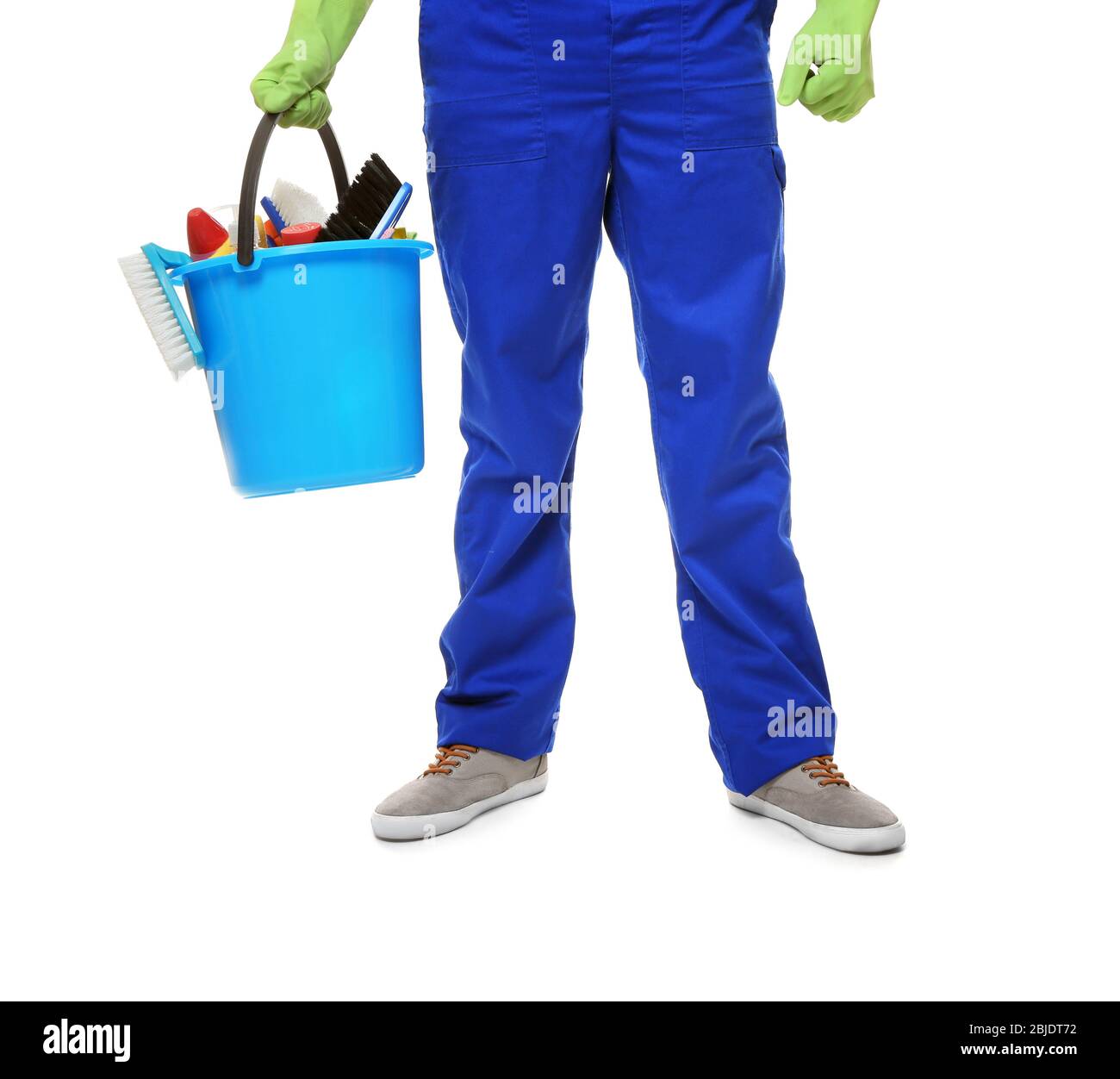 Young man holding bucket with cleaning equipment and supplies on white ...