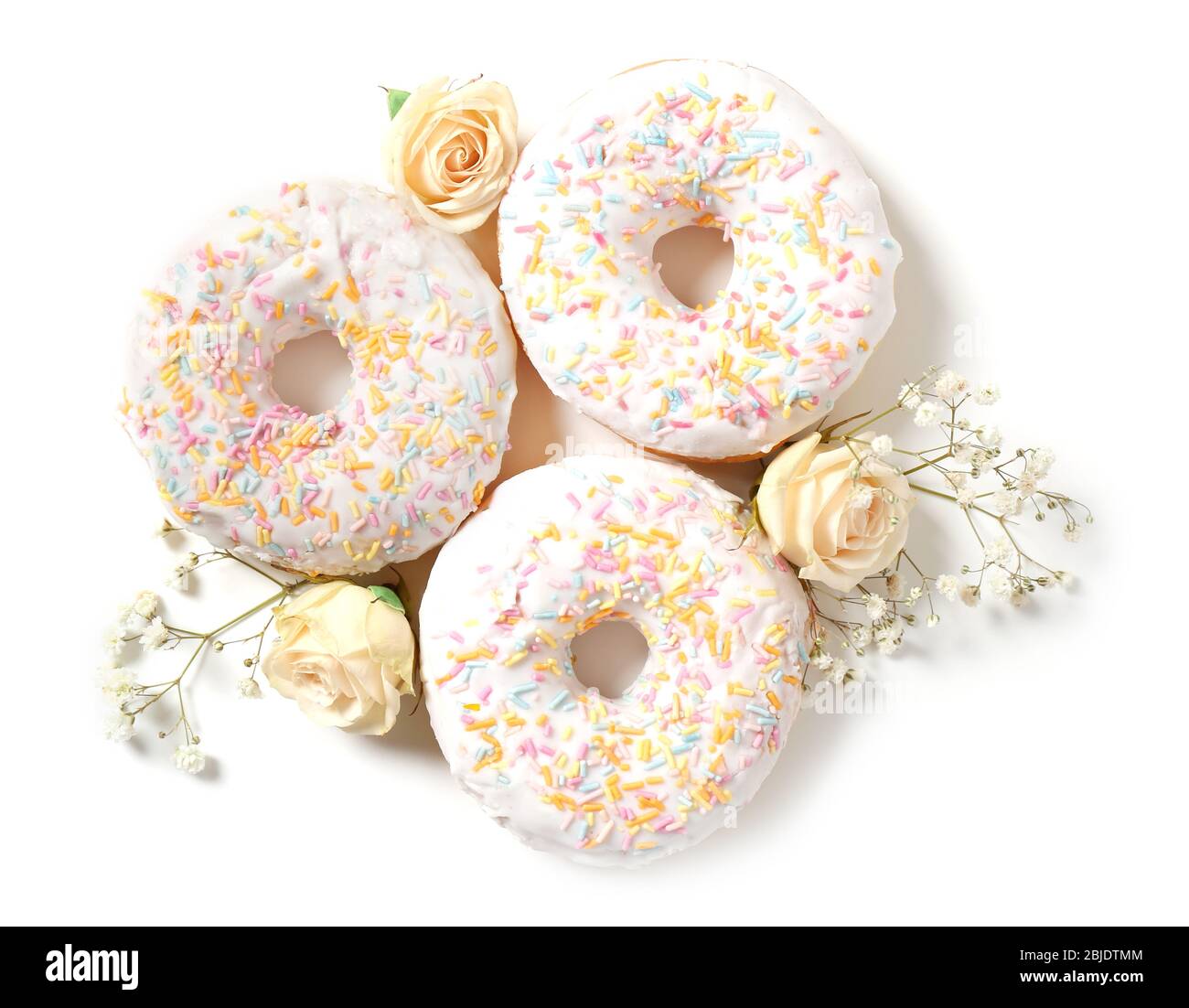 Delicious doughnuts and beautiful flowers on white background Stock ...