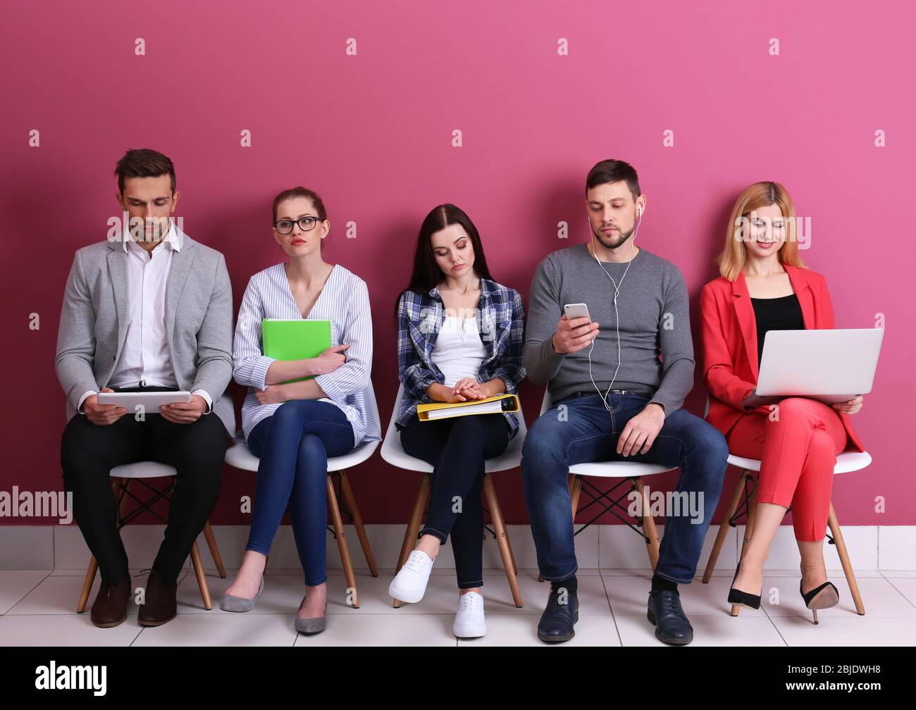 Group of people waiting for job interview on colour background Stock ...