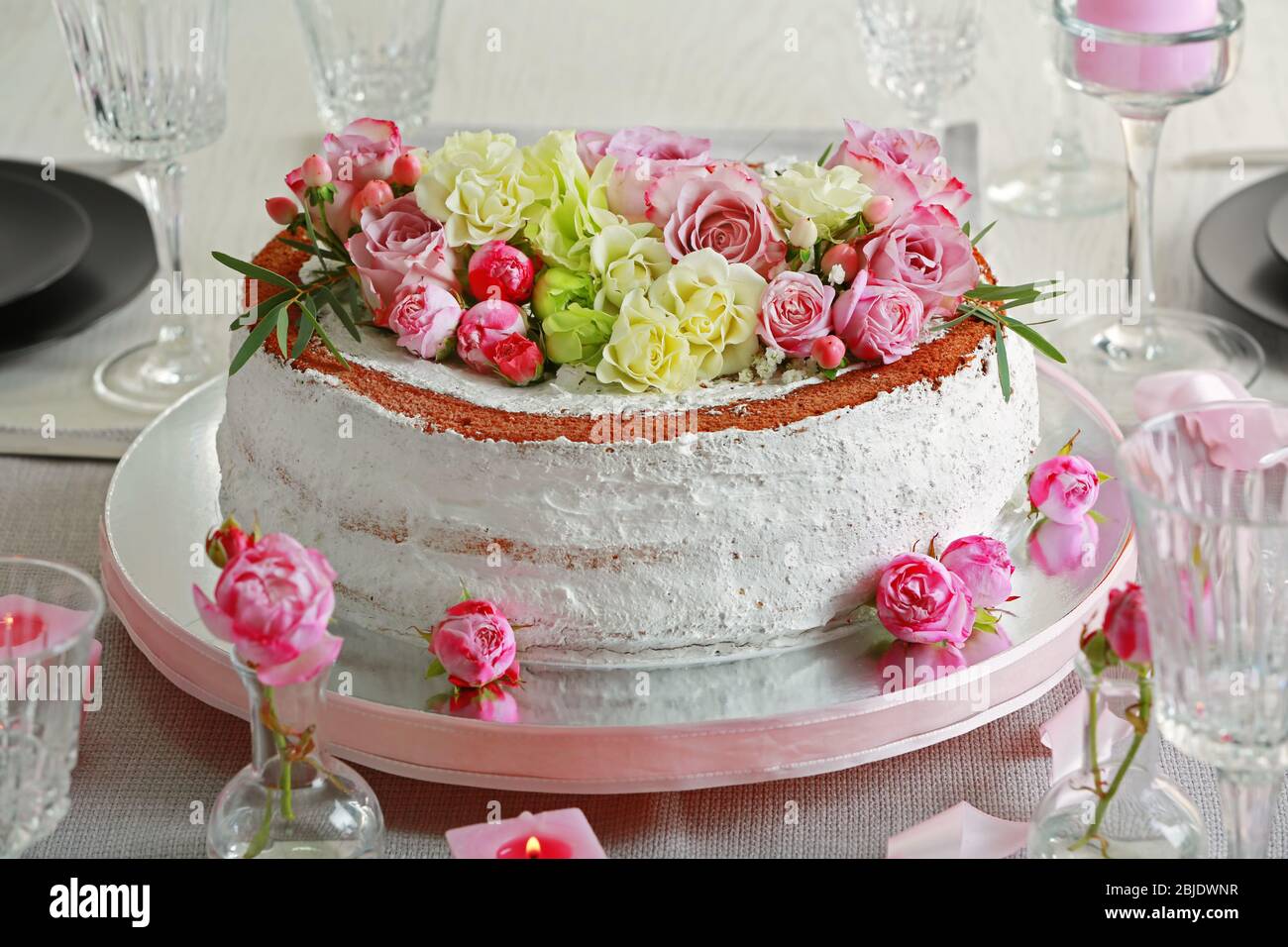 Delicious cake decorated with flowers on blurred background Stock Photo ...