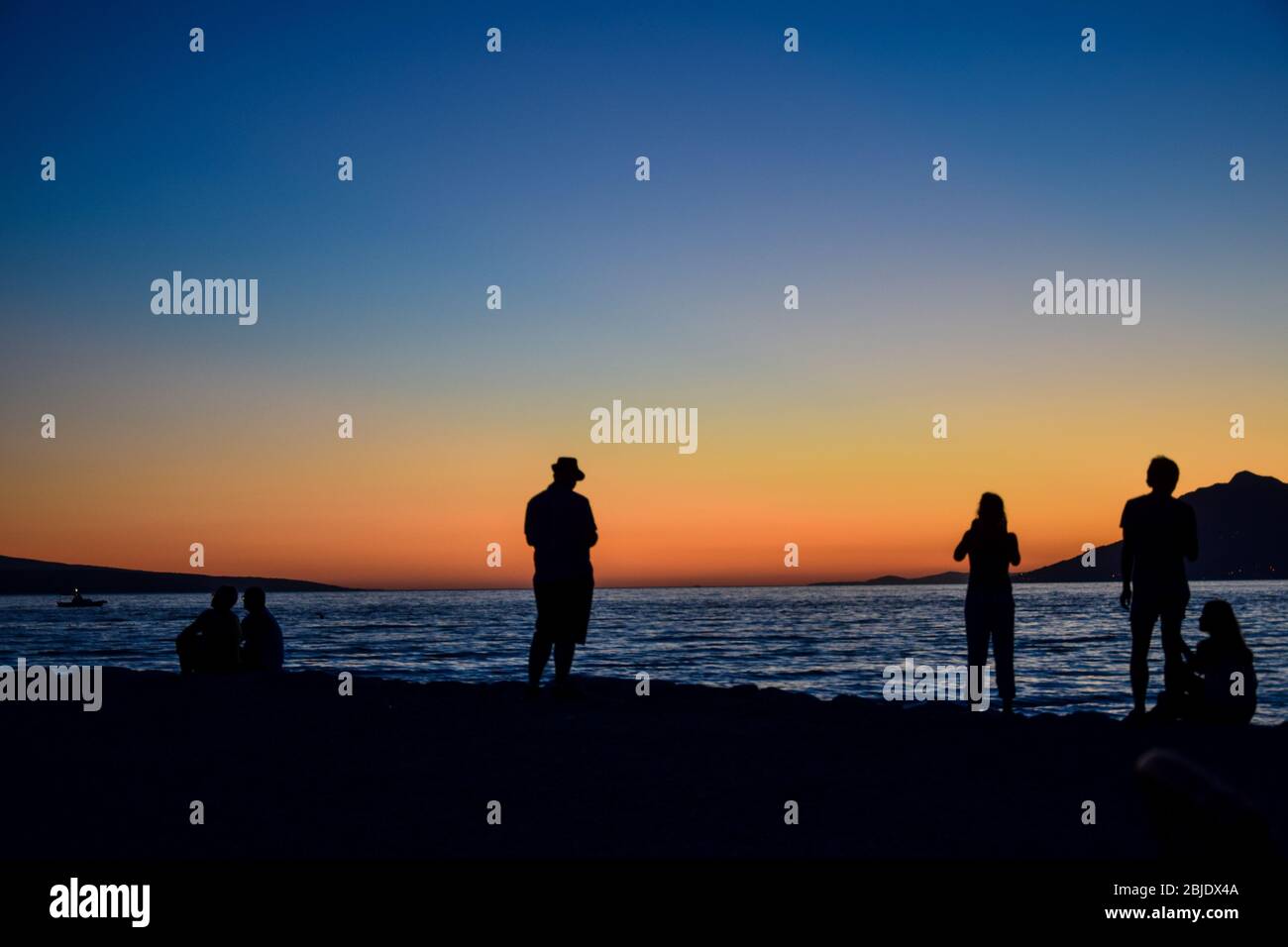 Standing in sunset at beach Stock Photo - Alamy