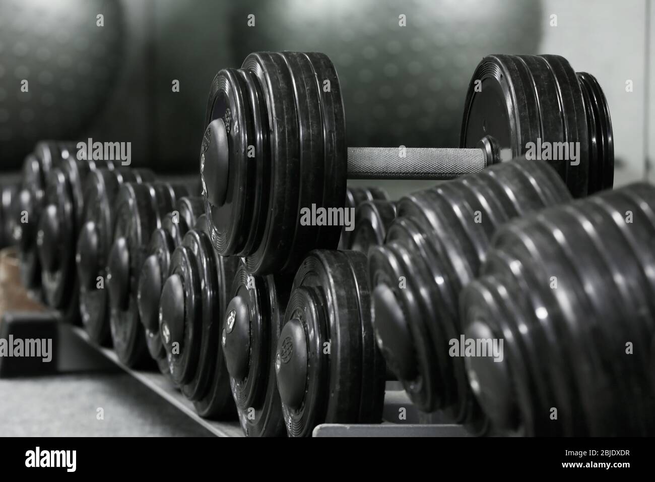 Dumbbells at the gym, close up Stock Photo - Alamy
