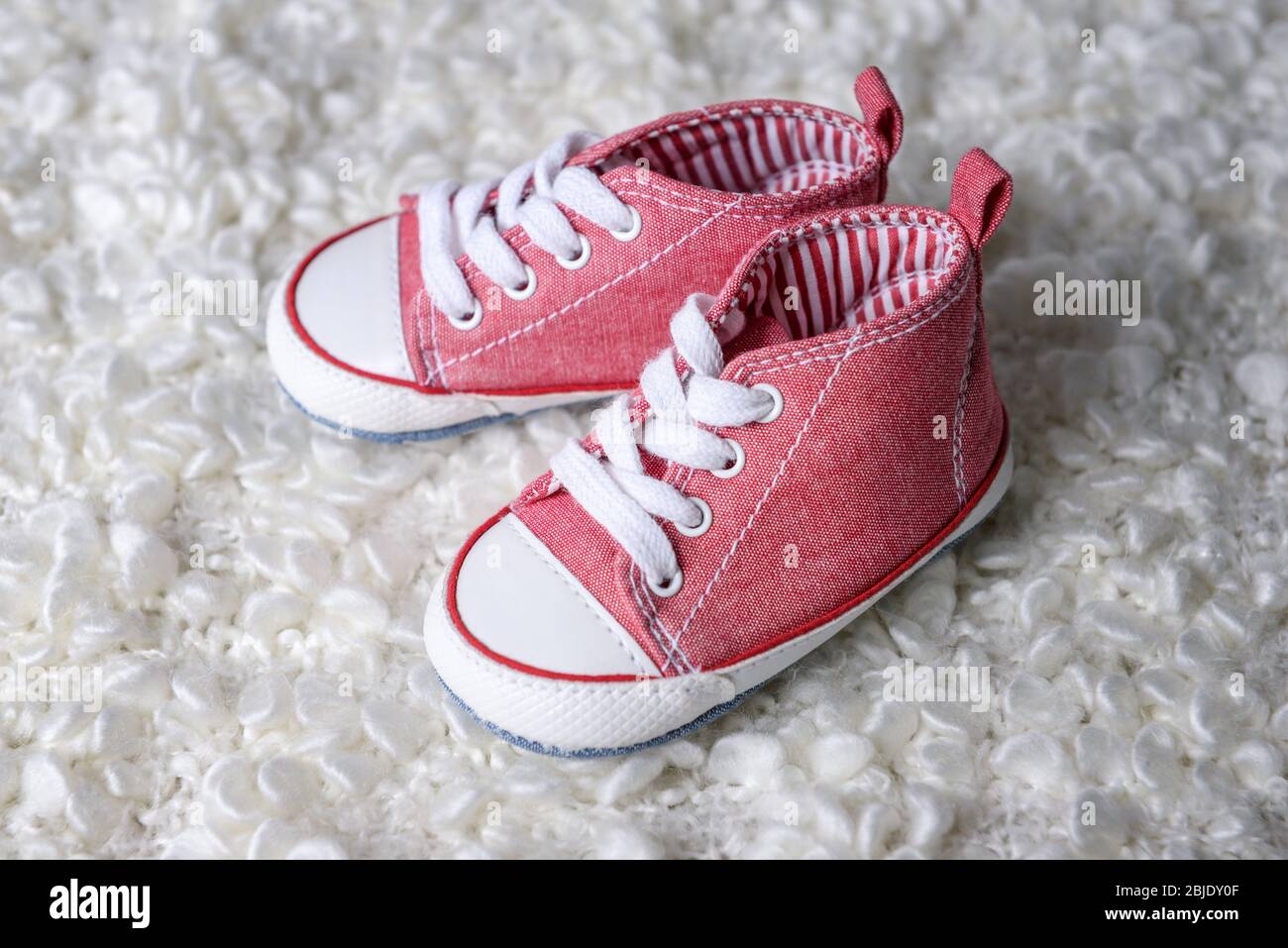 Cute baby shoes on soft plaid Stock Photo - Alamy