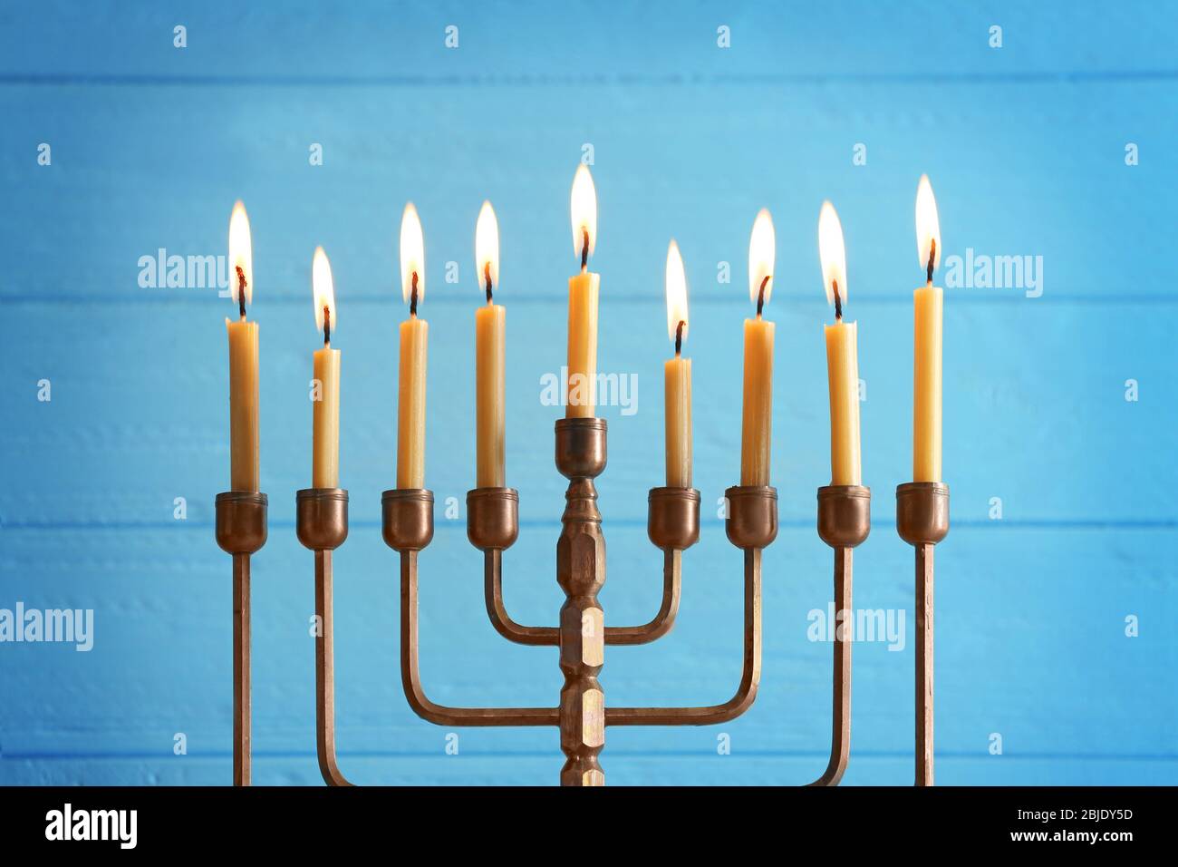 Menorah with candles for Hanukkah on blurred wooden background, close ...
