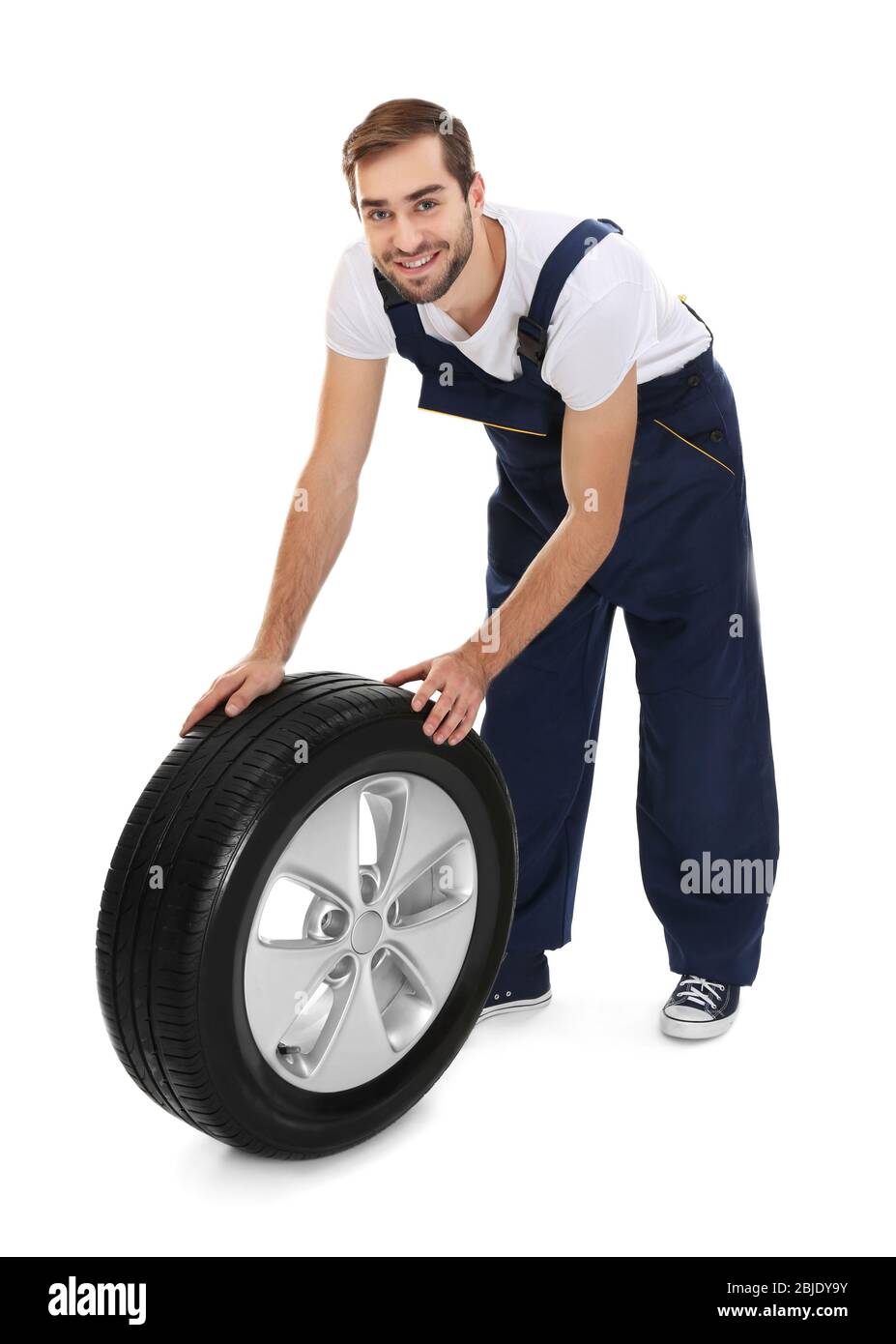 Young worker repairing car Cut Out Stock Images & Pictures - Alamy