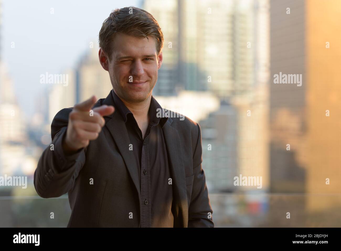 Businessman pointing winking hi-res stock photography and images - Alamy